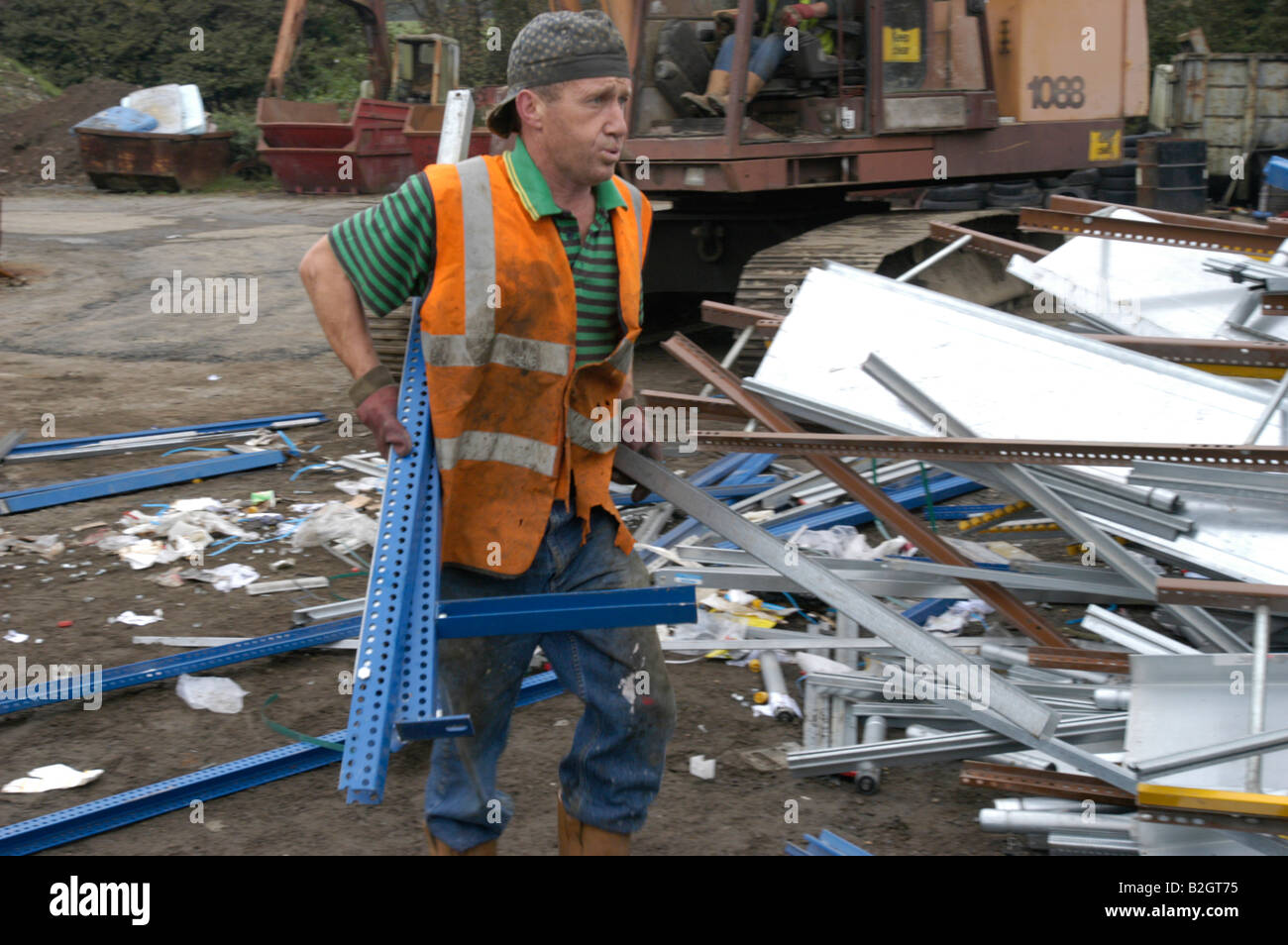 A scrap worker grades metal for recycling Stock Photo - Alamy