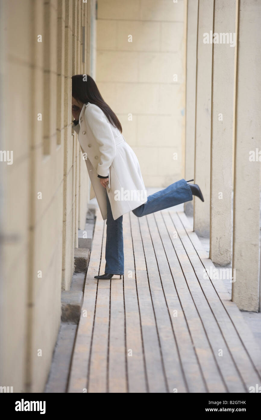 Side profile of a young woman peeking in a room Stock Photo - Alamy