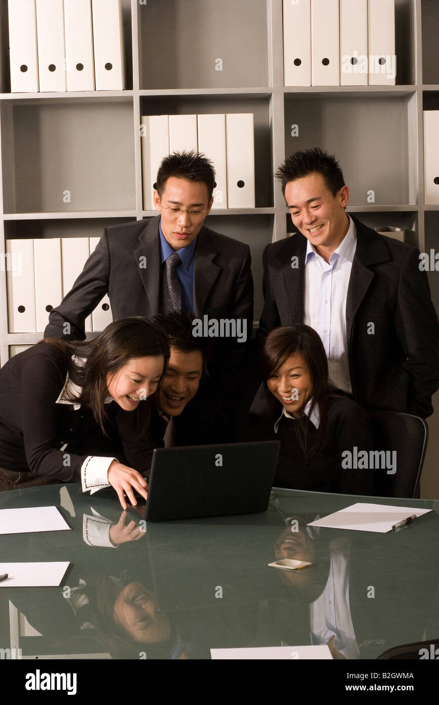 Five business executives using a laptop in an office Stock Photo - Alamy