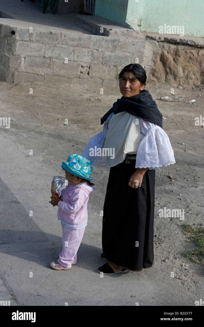 Woman with child on street corner, Quito Pichincha province, Ecuador ...