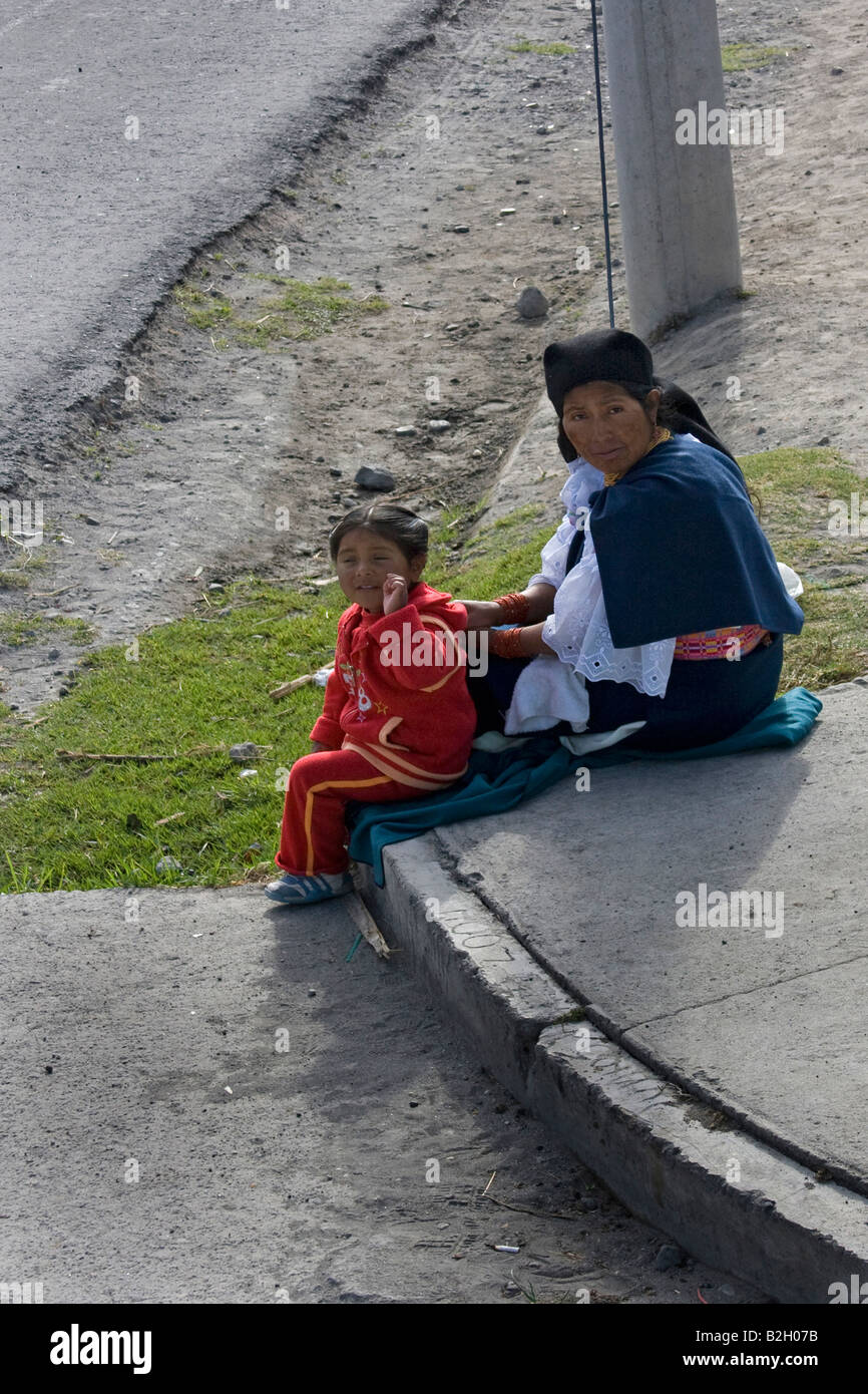 Woman with child on street corner, Quito Pichincha province, Ecuador ...