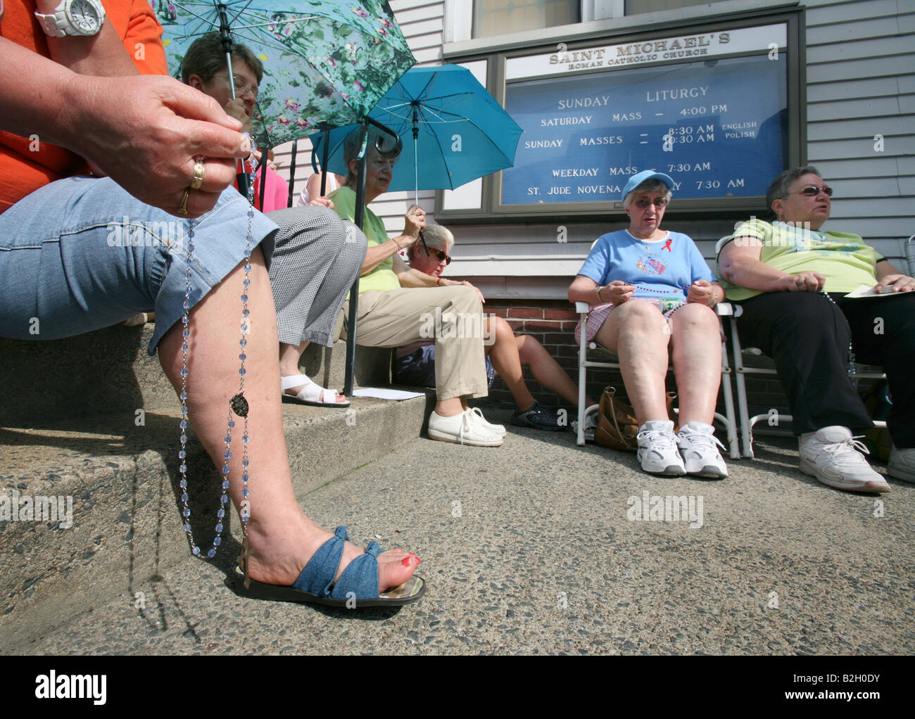 Women pray outside a Roman Catholic church in an attempt to stop its ...