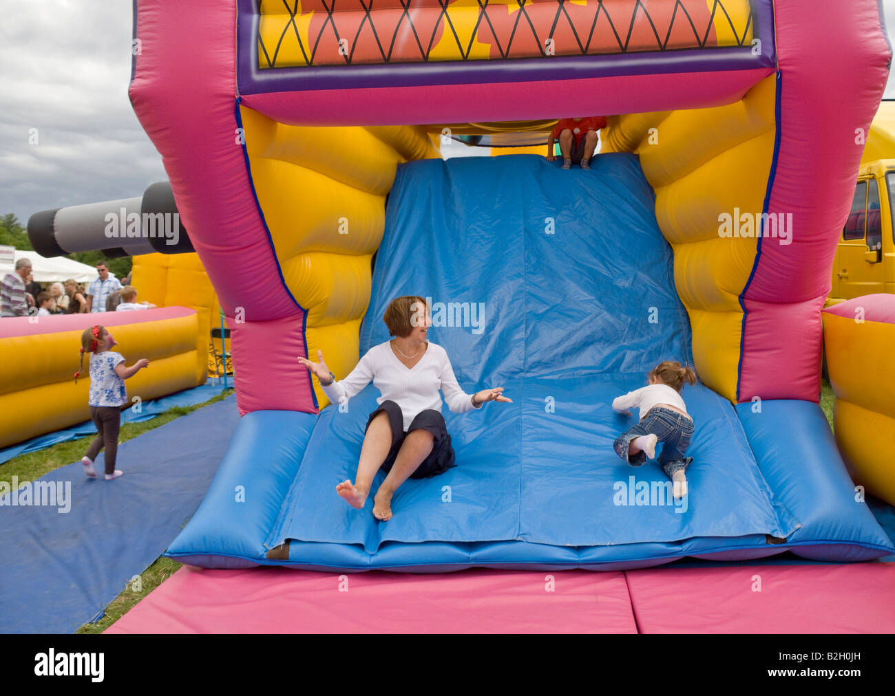 Adult and children enjoying the inflatable slide at the St. Ives ...
