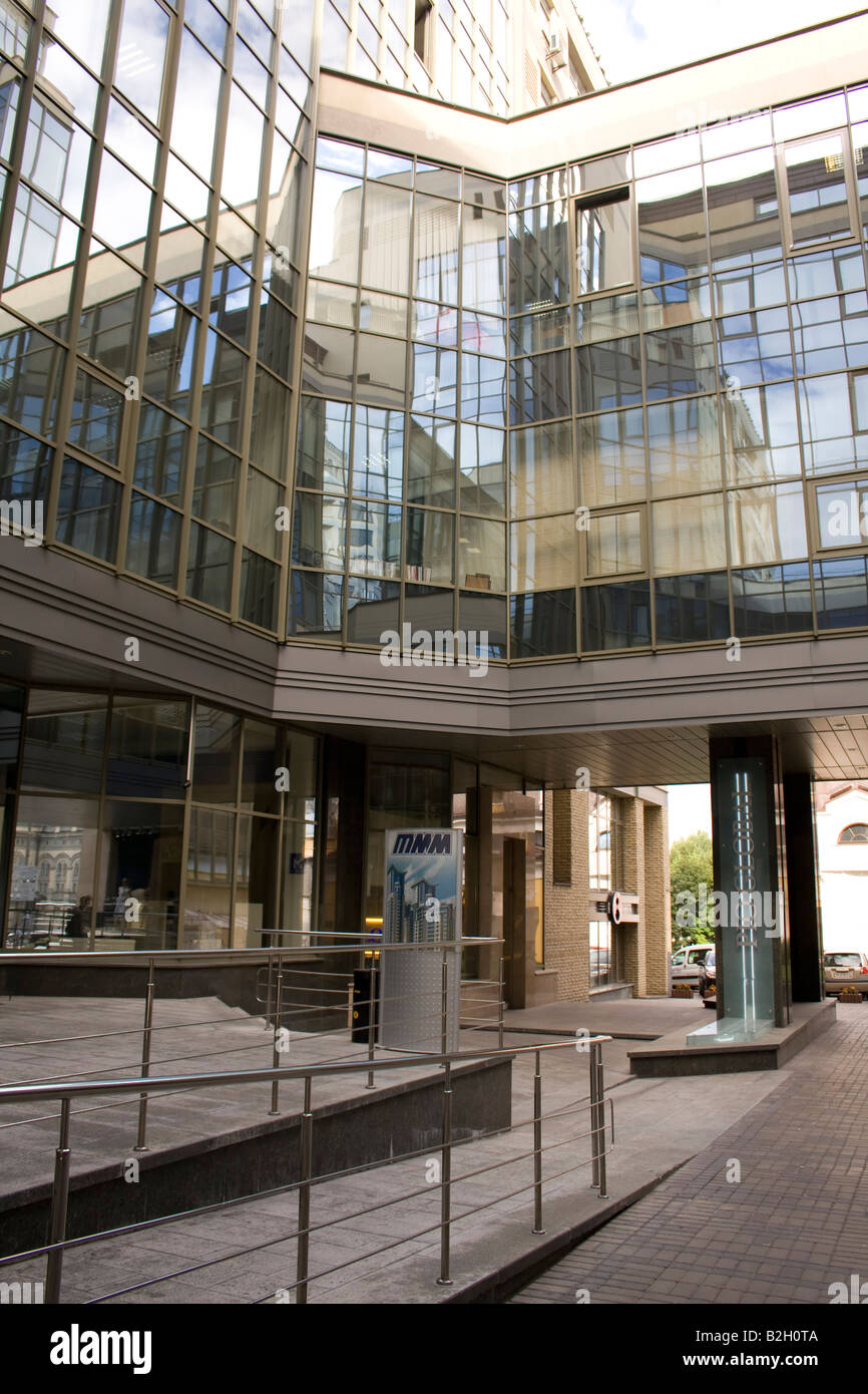 Modern glass building facade with reflective windows, metal railings ...