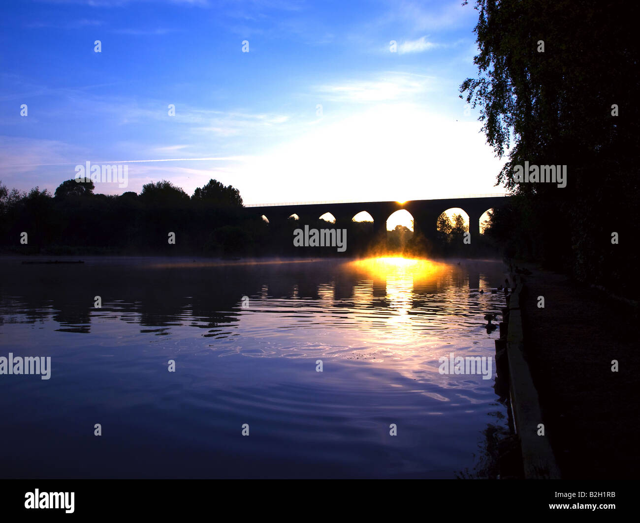 Train crossing viaduct at sunset hi-res stock photography and images ...