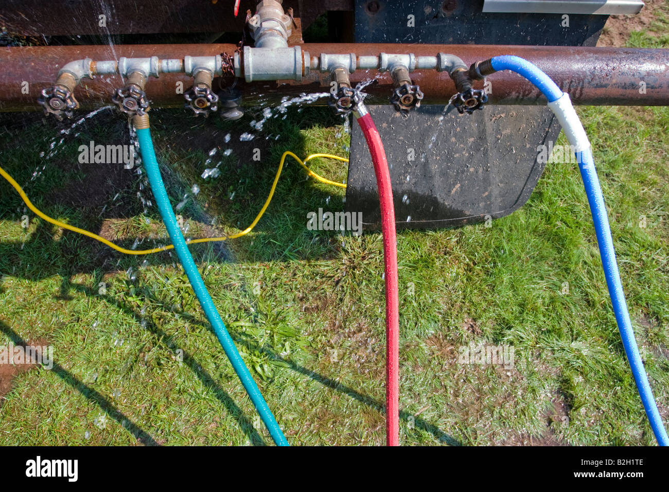 Colored water hoses attached to a water truck Stock Photo - Alamy