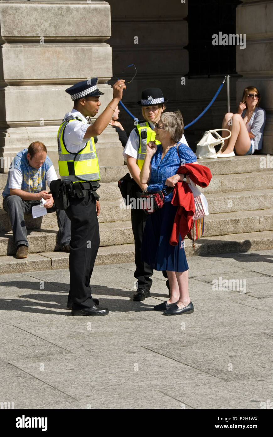 Policeman policewoman giving directions woman hi-res stock photography ...
