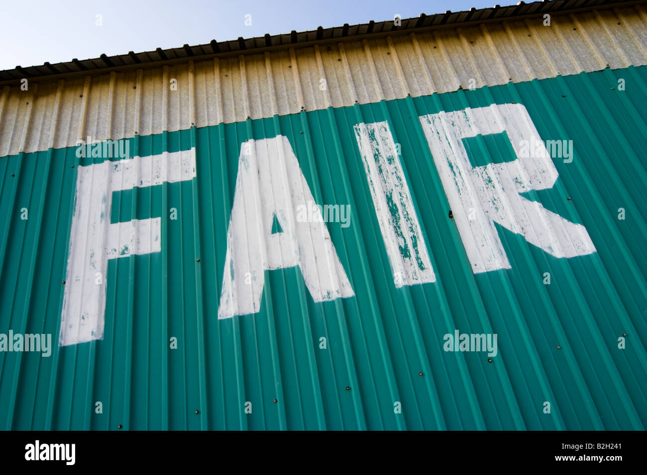 Green metal wall with FAIR written on it Stock Photo - Alamy