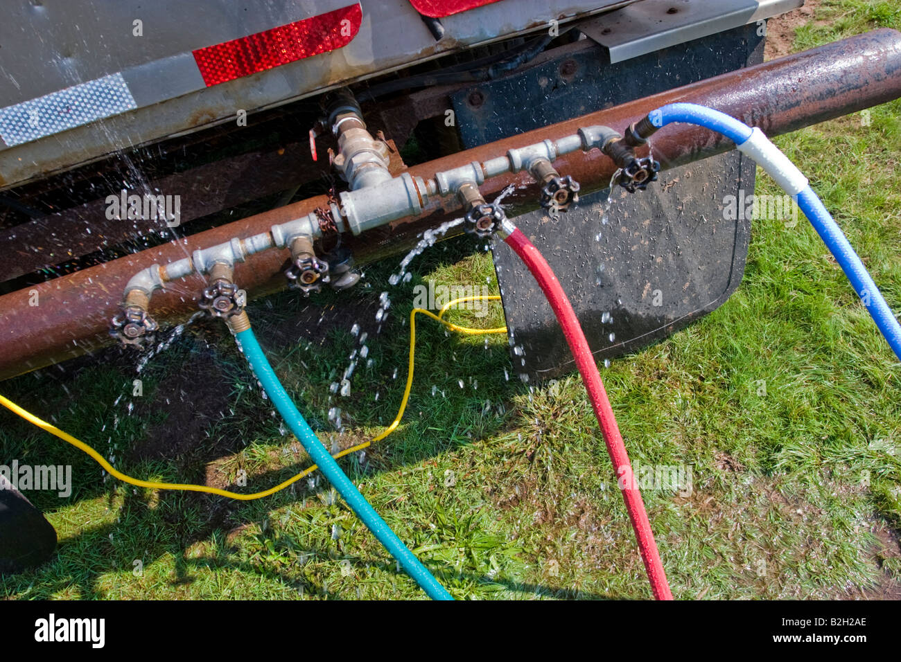 Colored water hoses attached to a water truck Stock Photo - Alamy
