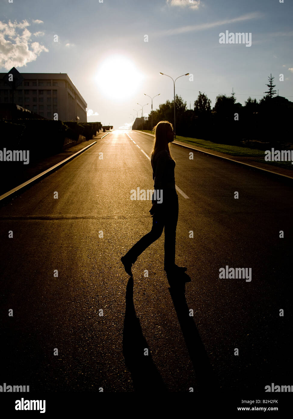 A girl walking in the rays of sun Stock Photo - Alamy