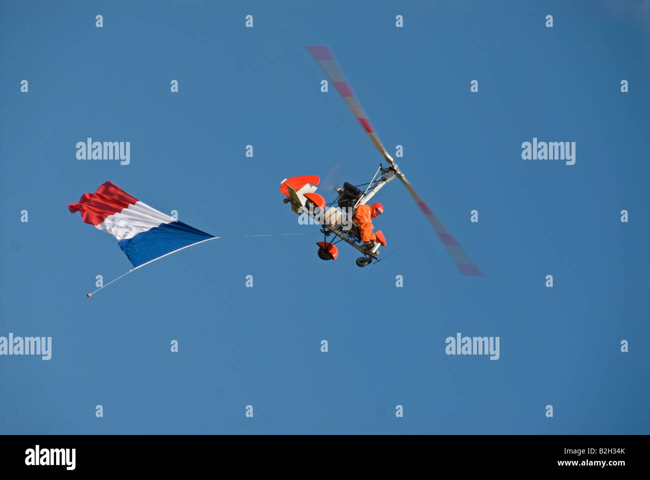 Stock photo of a single autogyro with the french flag flying beneath it ...