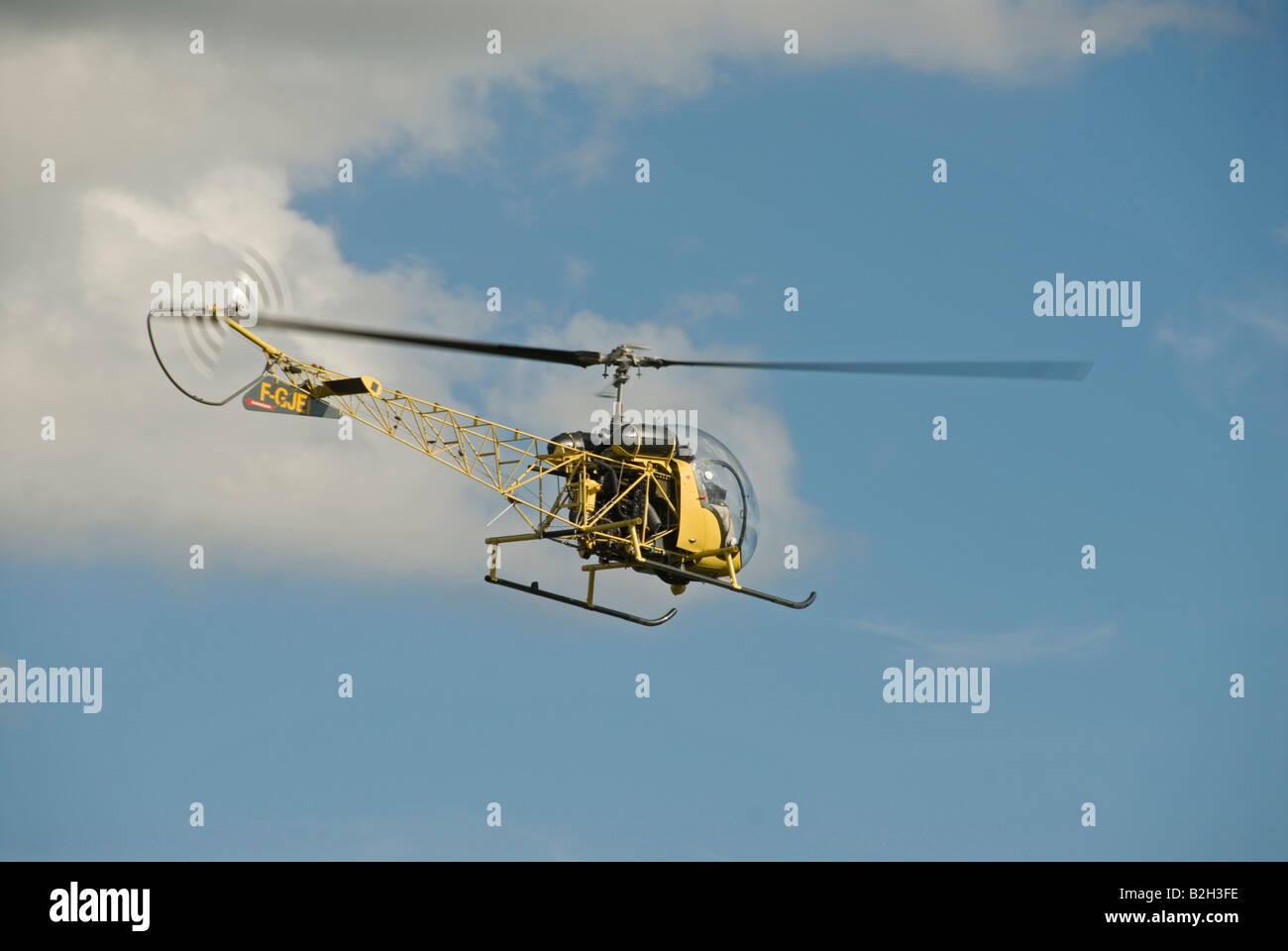 Stock photo o a yellow helicopter flying in the sky Stock Photo - Alamy