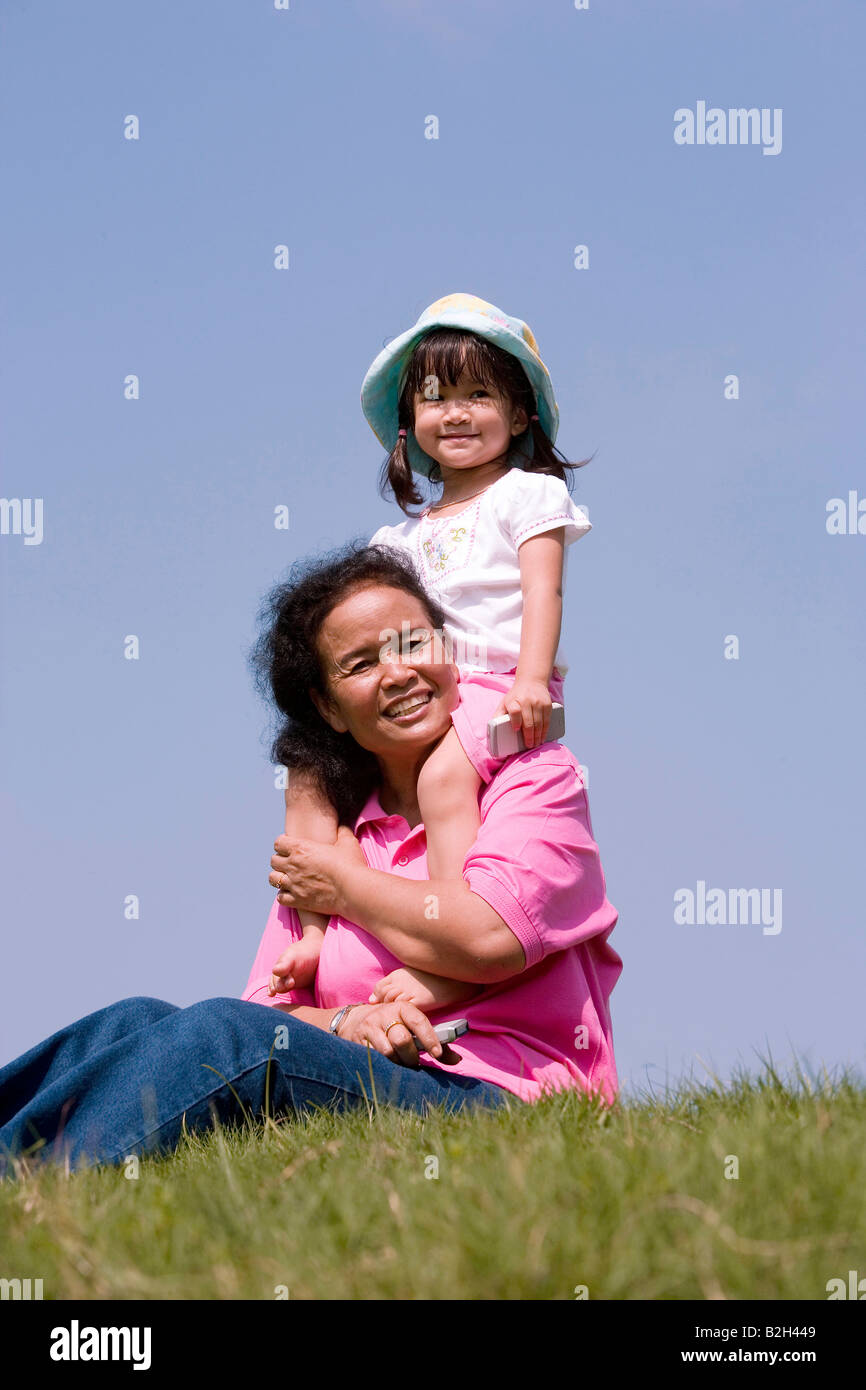 Grandmother carrying granddaughter on shoulders hi-res stock ...