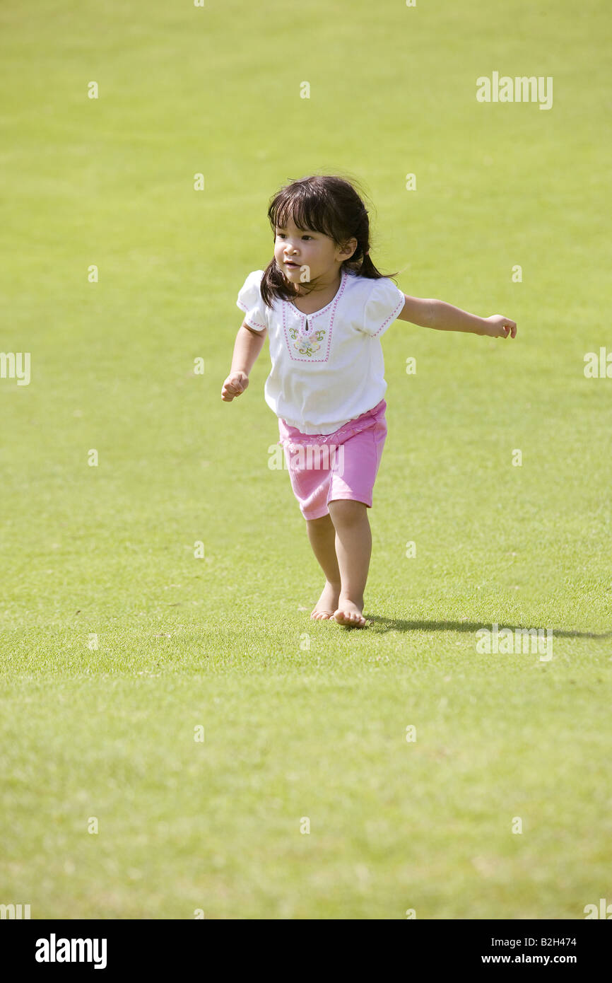Girl walking in a park Stock Photo - Alamy