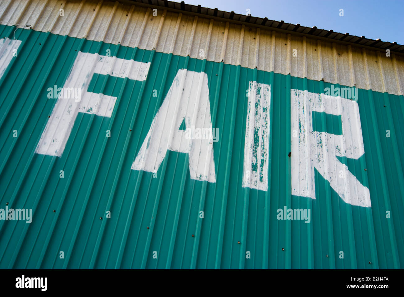 Green metal wall with FAIR written on it Stock Photo - Alamy