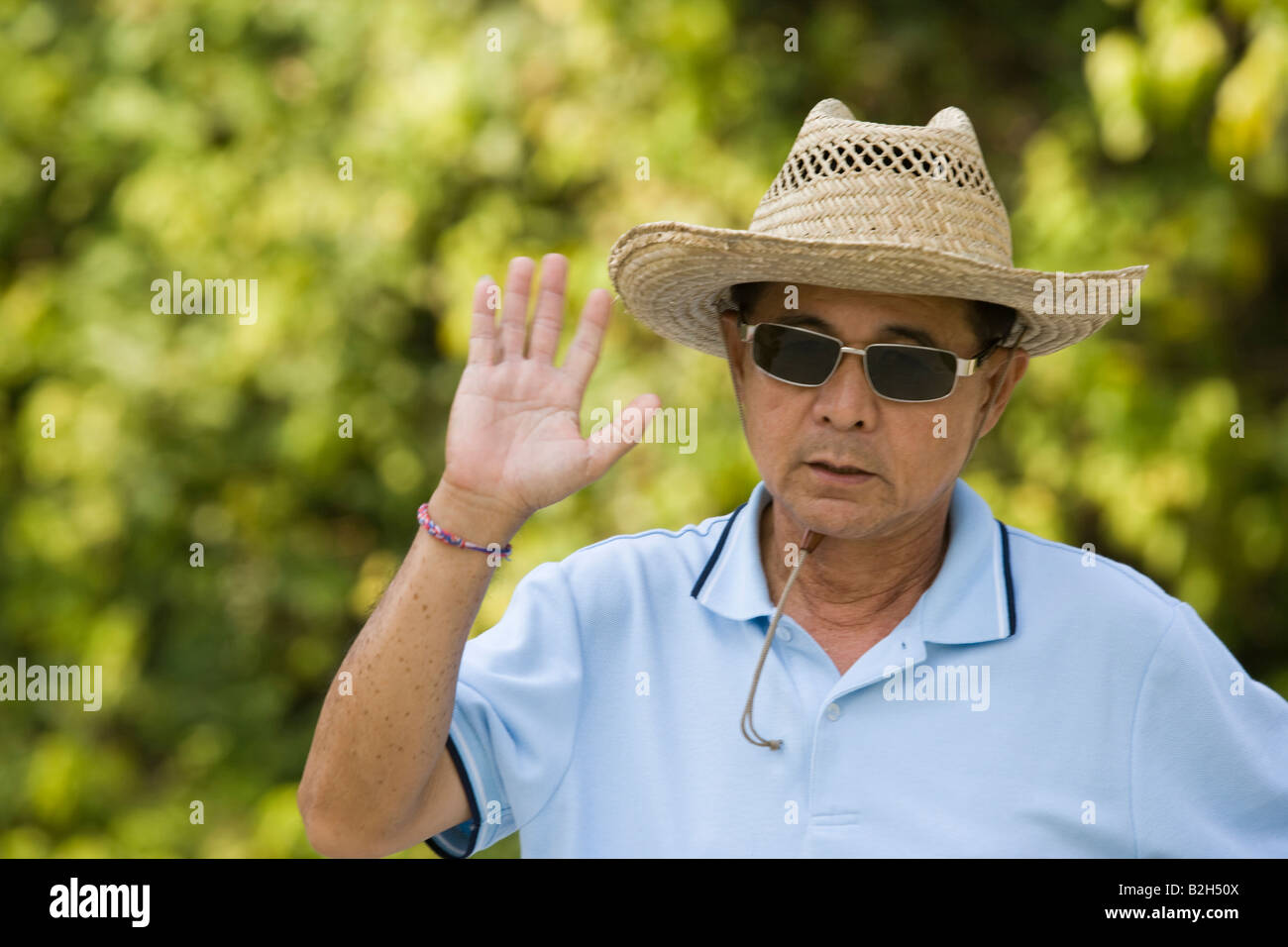 Portrait of a mature man waving his hand Stock Photo - Alamy