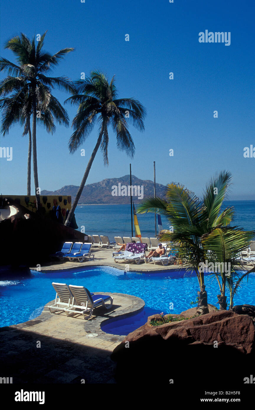 Tourists relaxing beside a hotel swimming pool in the Zona Dorada or ...