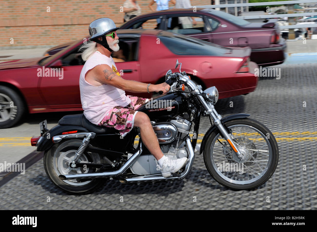 Adult senior male riding a motorcycle wearing a protective helmet Stock ...