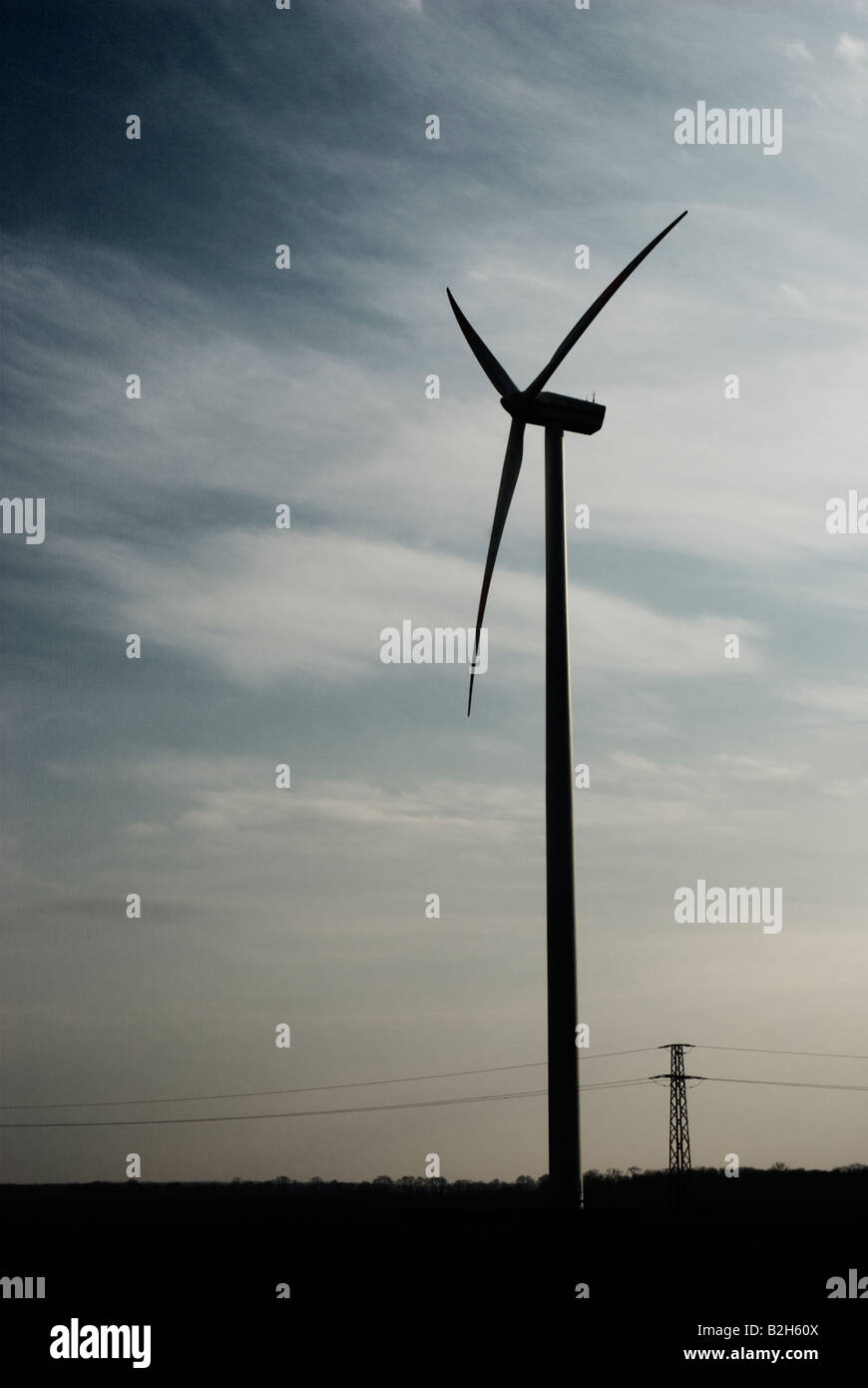 Wind turbine and electricity pylon Stock Photo - Alamy