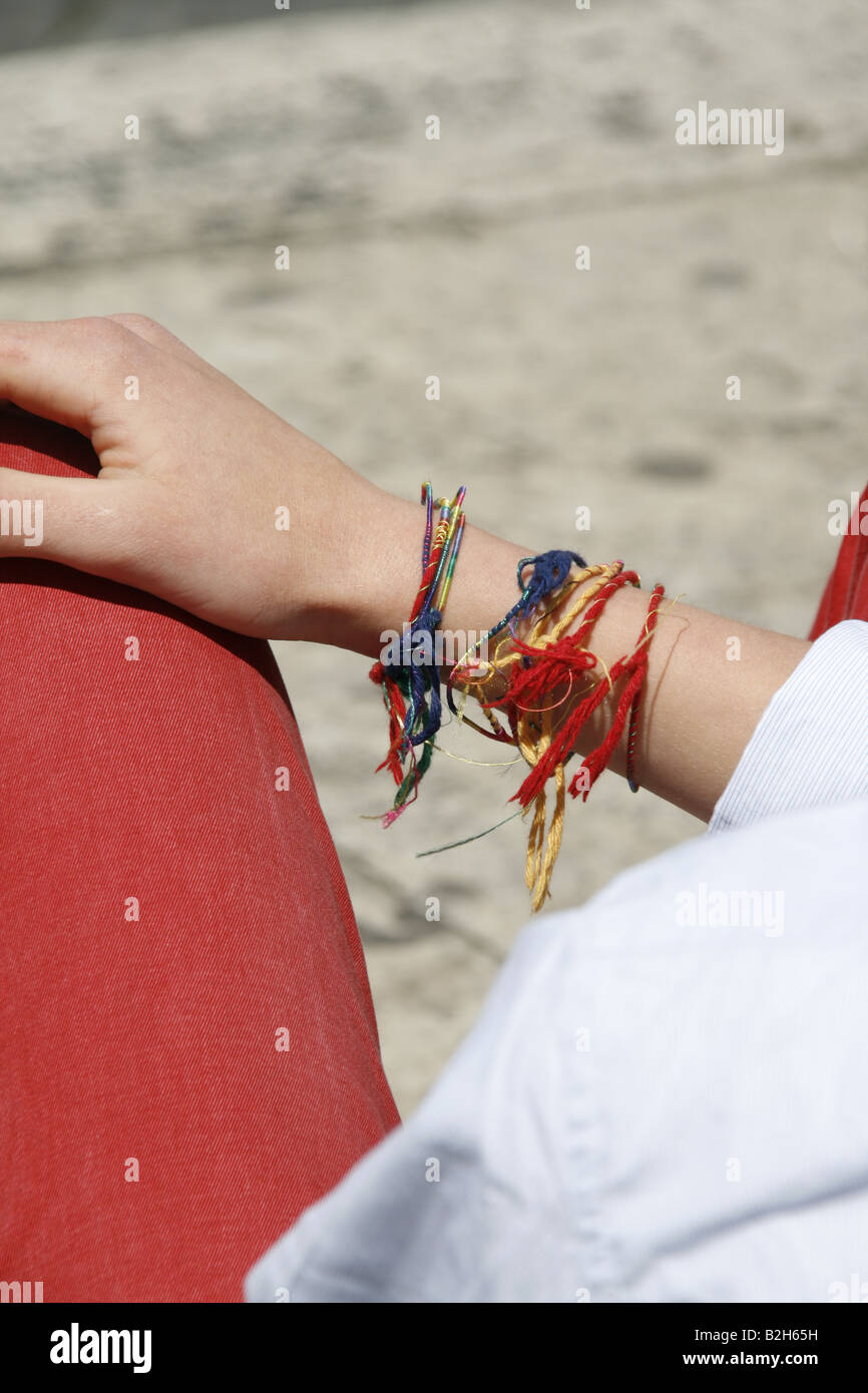 detail teenage man wearing colourful string bracelets Stock Photo - Alamy