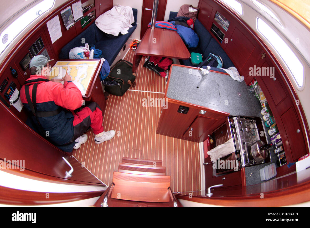 man plotting course whilst sailing a small yacht in the Firth of Clyde ...