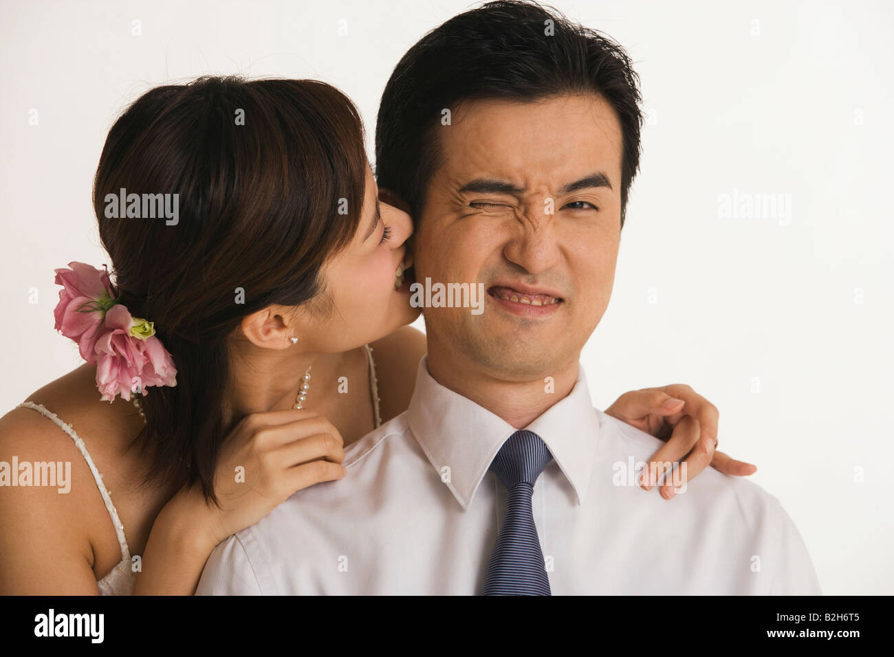 Close-up of a bride biting her groom's ear Stock Photo - Alamy
