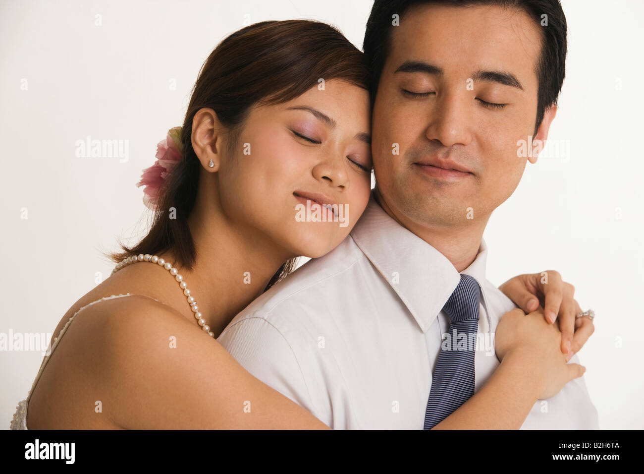 Close-up of a bride embracing her groom Stock Photo - Alamy
