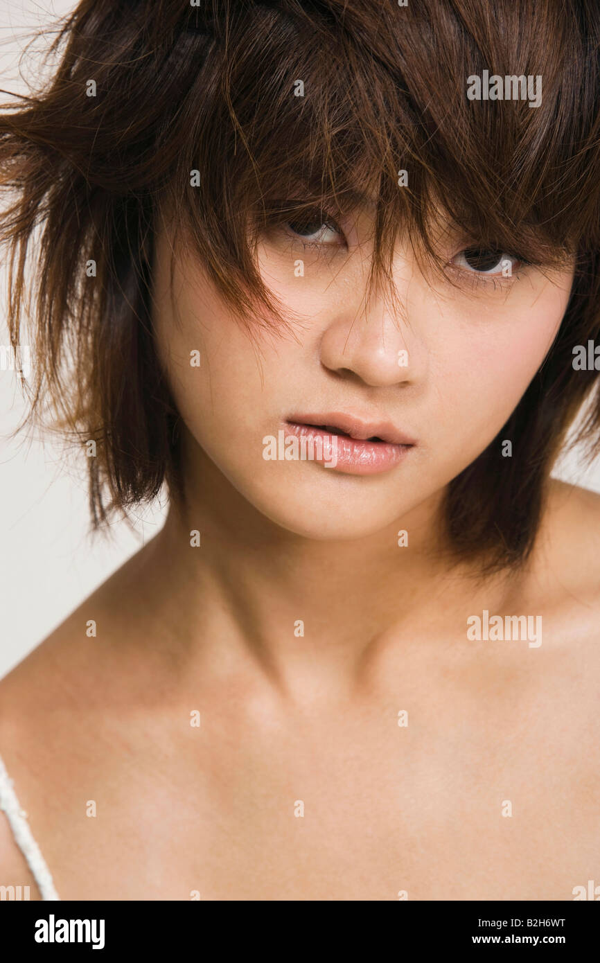 Portrait of a young woman looking serious Stock Photo - Alamy