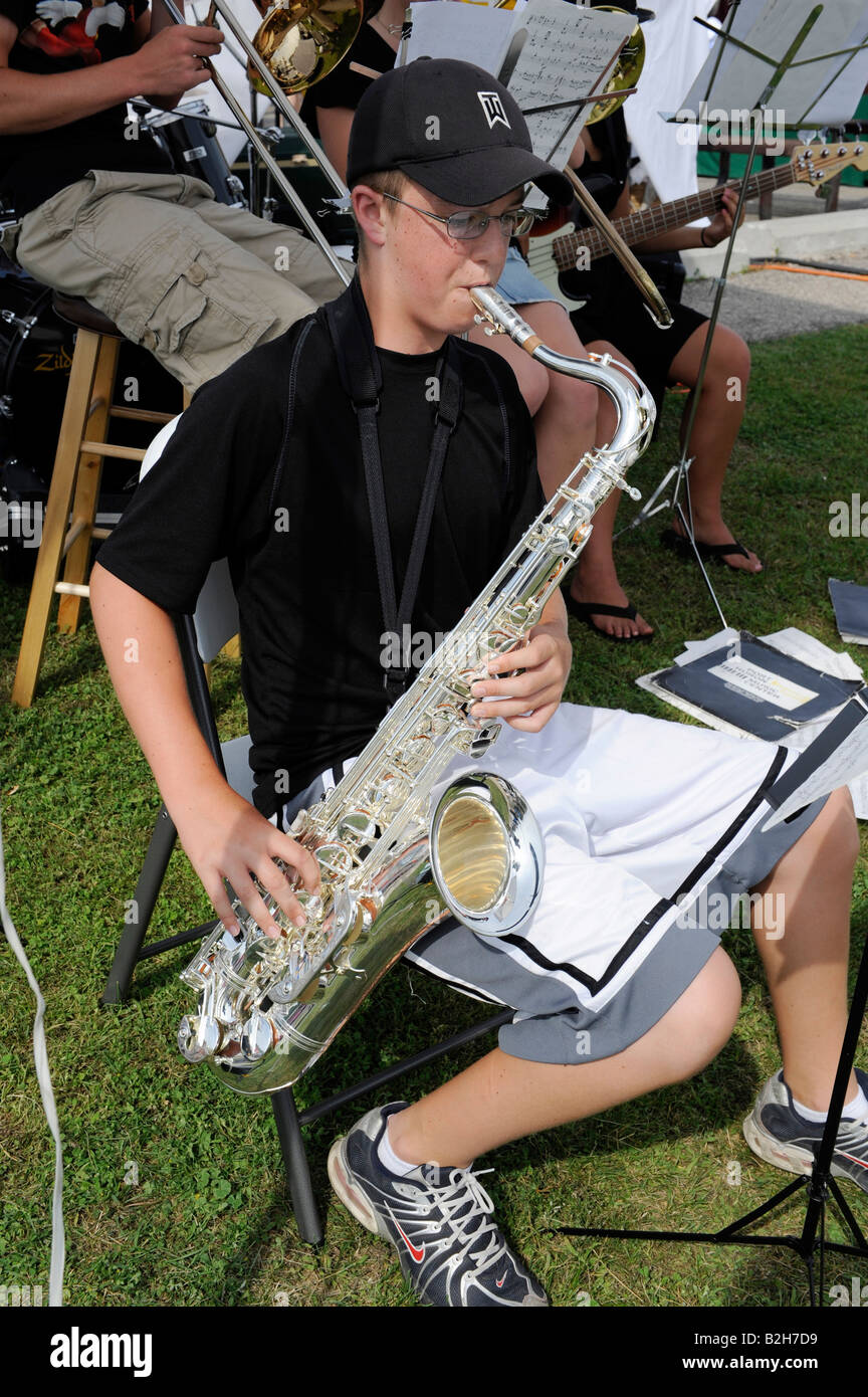 High school boy playing a saxaphone Stock Photo - Alamy