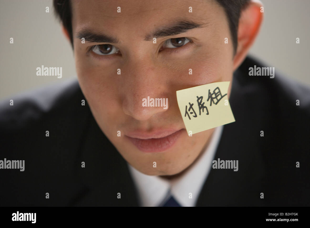 Portrait of a businessman with adhesive note on his cheek Stock Photo ...