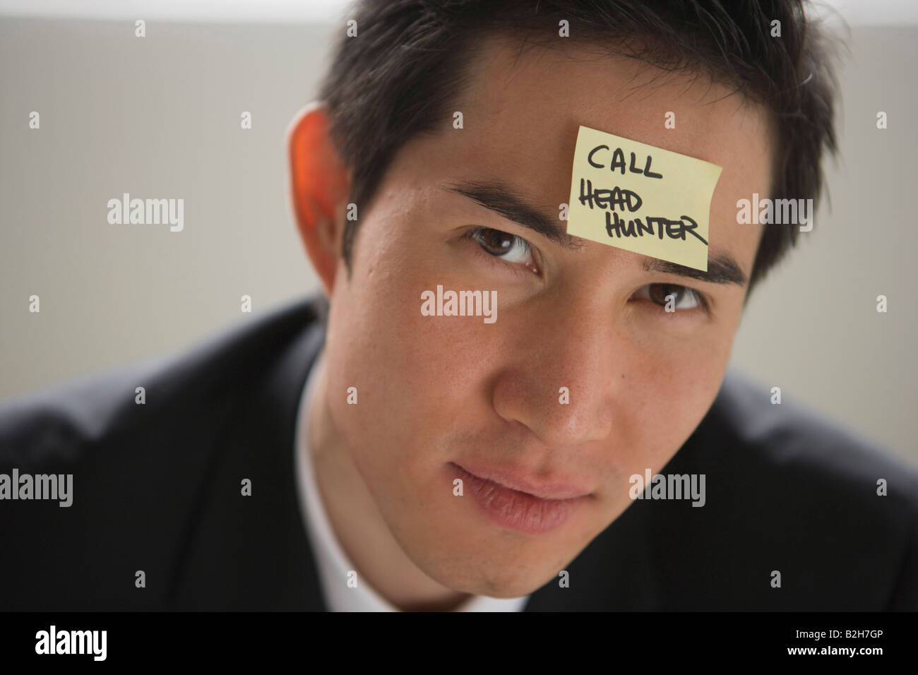 Portrait of a businessman with an adhesive note on his forehead Stock ...