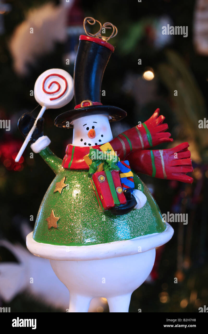 A decorative christmas snowman holding gifts and waving very blurry ...