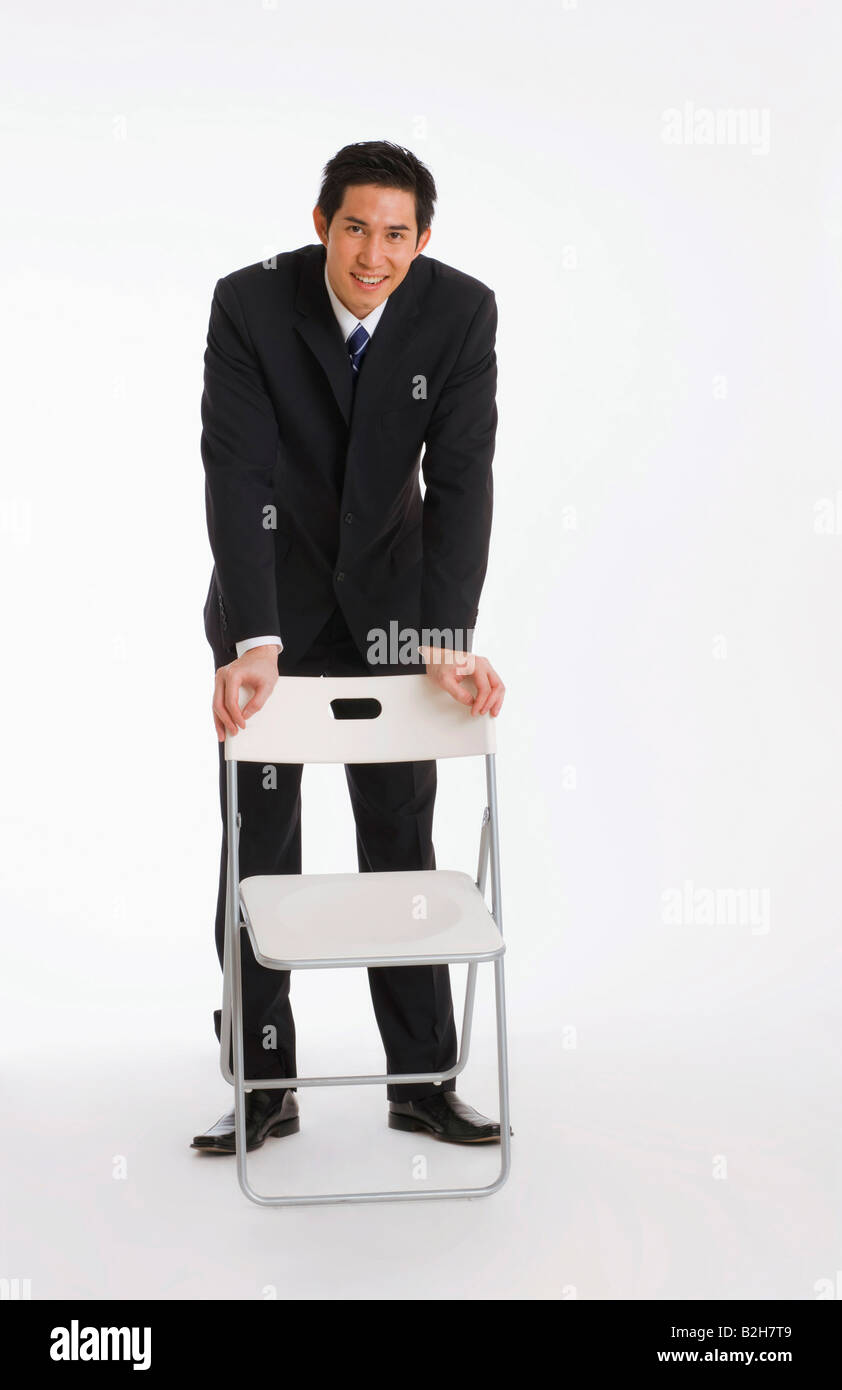 Portrait of a businessman standing and smiling Stock Photo - Alamy