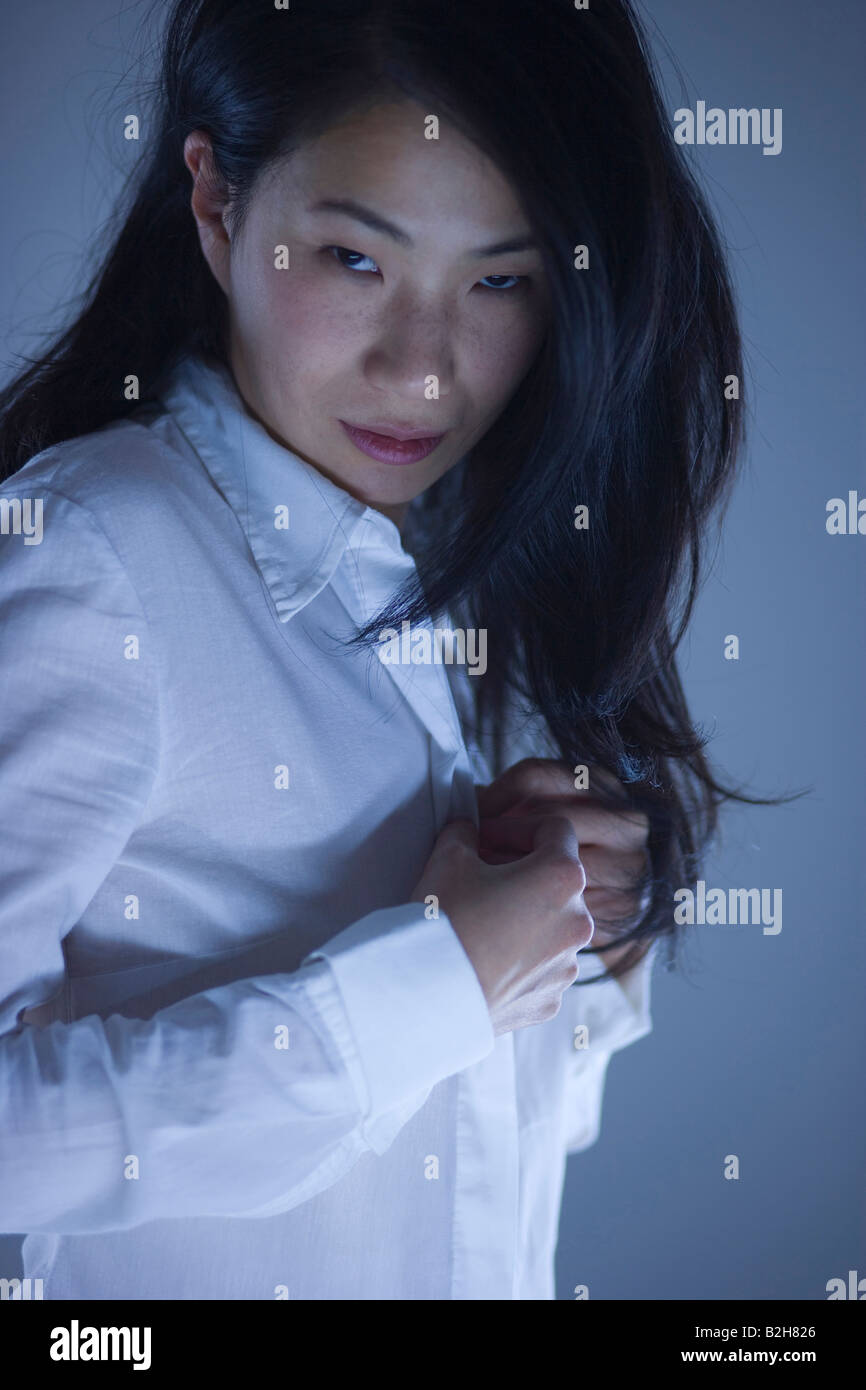 Woman buttoning up shirt hi-res stock photography and images - Alamy