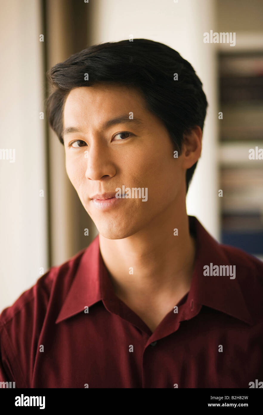 Portrait of a young man smirking Stock Photo - Alamy