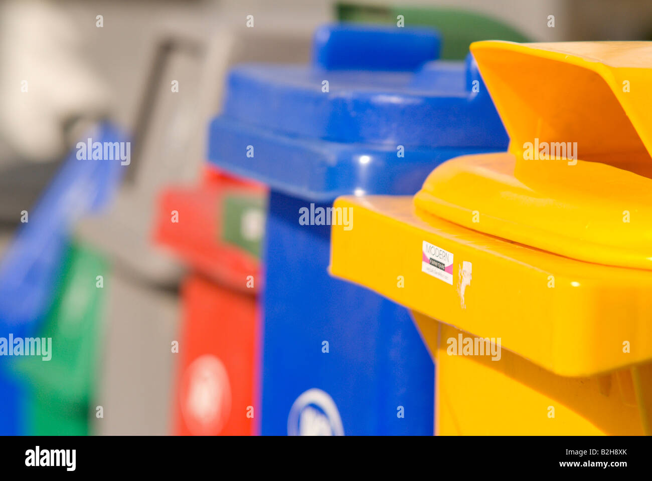Multi colored trash cans in a row Stock Photo - Alamy
