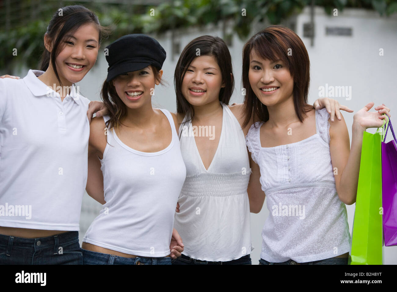 Portrait of four young women smiling Stock Photo - Alamy