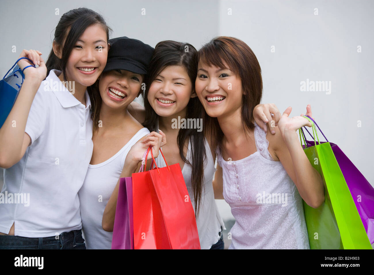 Portrait of four young women smiling Stock Photo - Alamy