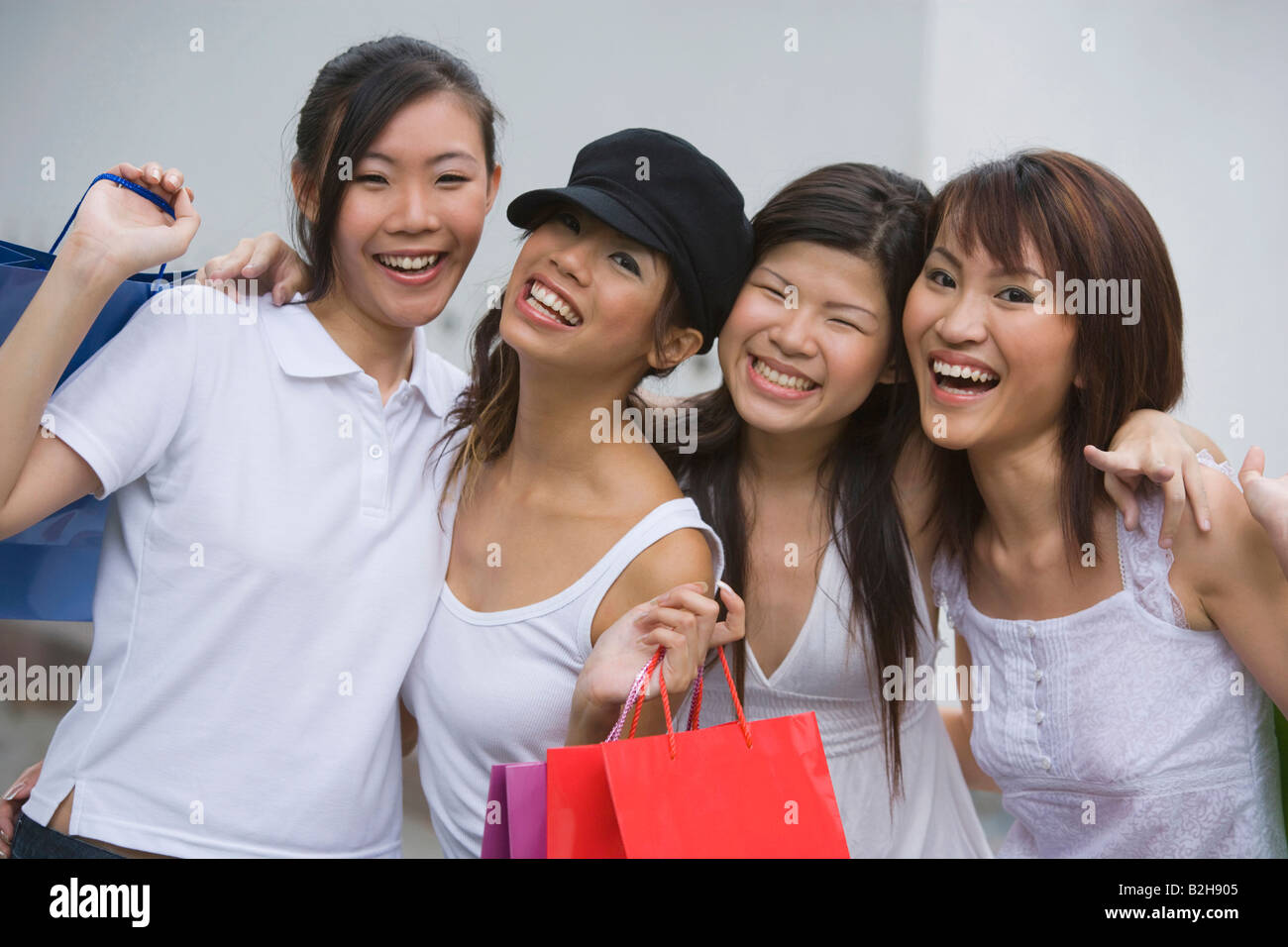 Portrait of four young women smiling Stock Photo - Alamy