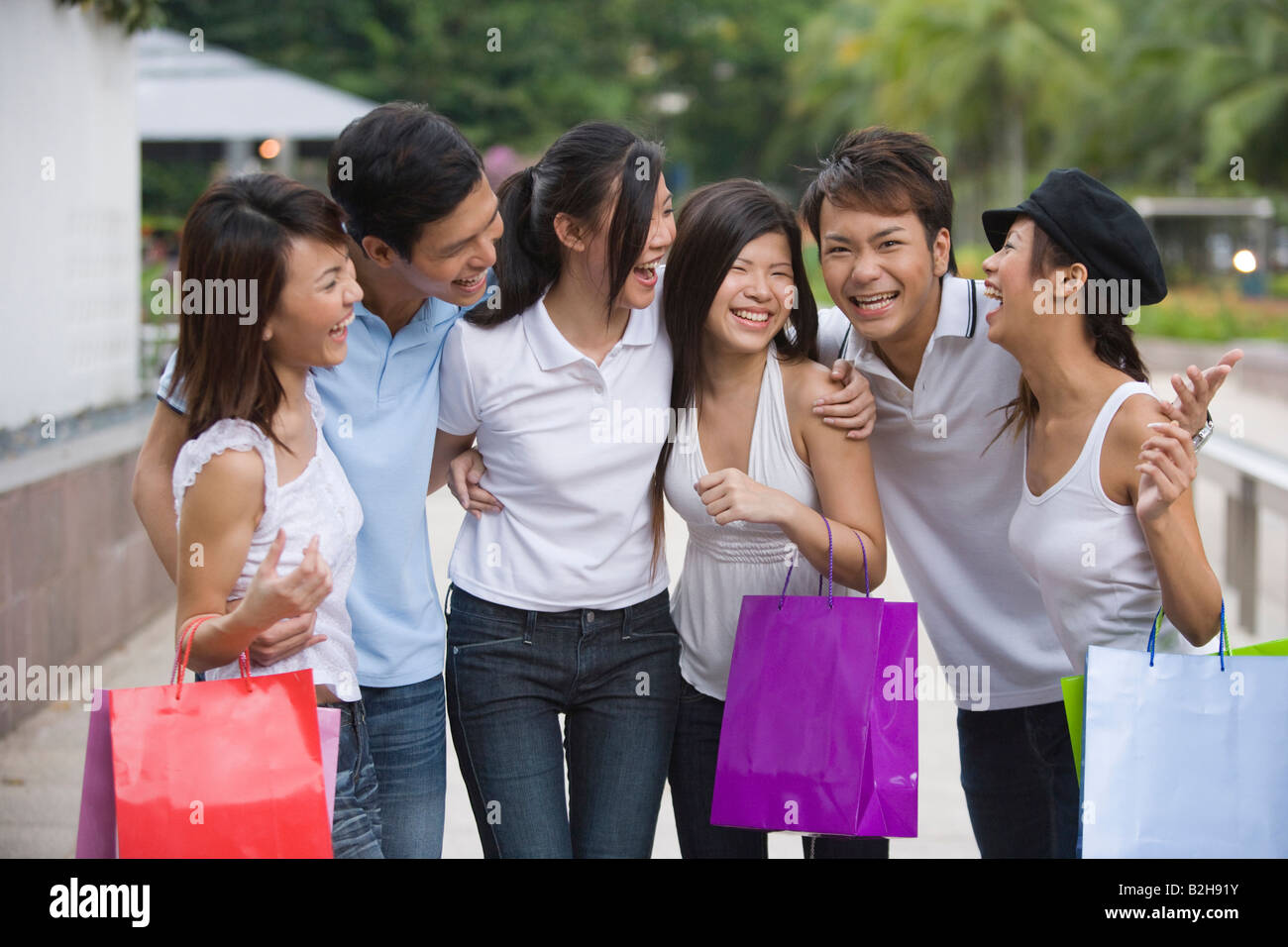 Group of friends standing together and smiling Stock Photo - Alamy