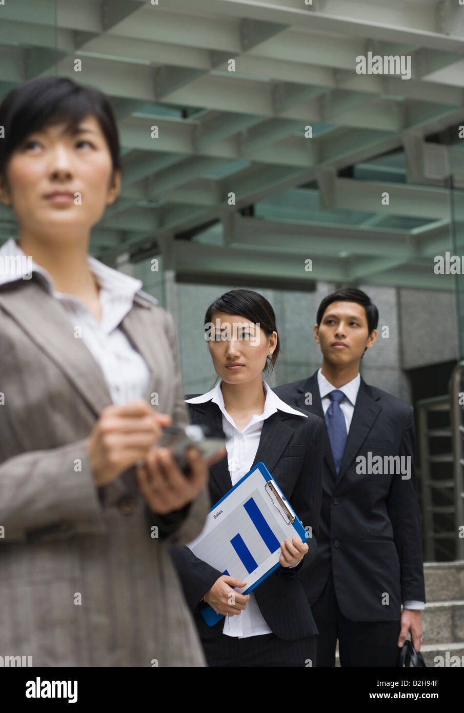 Three business executives standing outside an office Stock Photo - Alamy