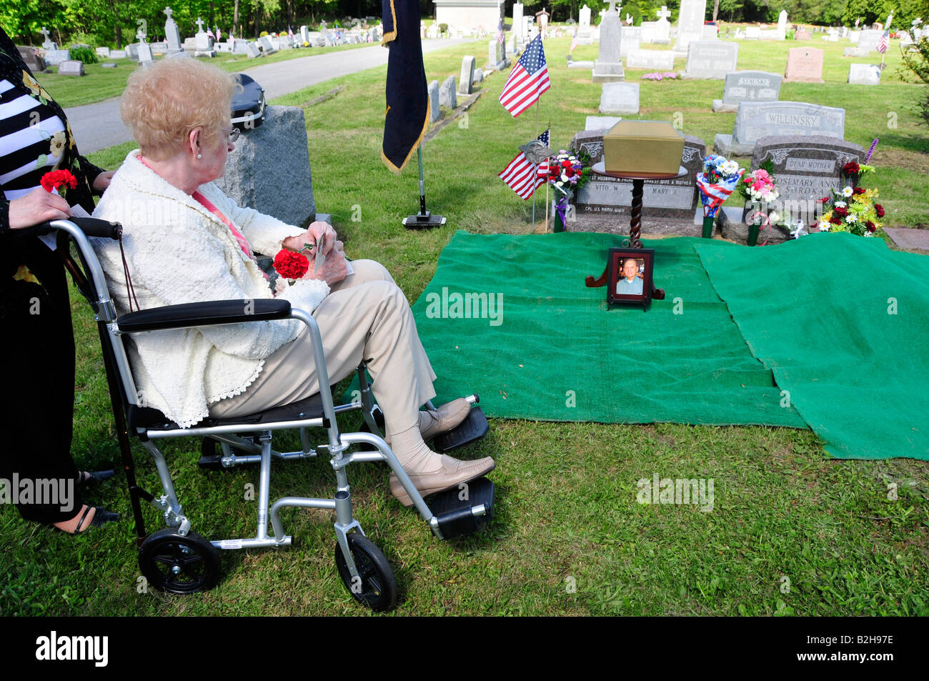 Wife with the ashes of dead husband and father prior to burial in a ...