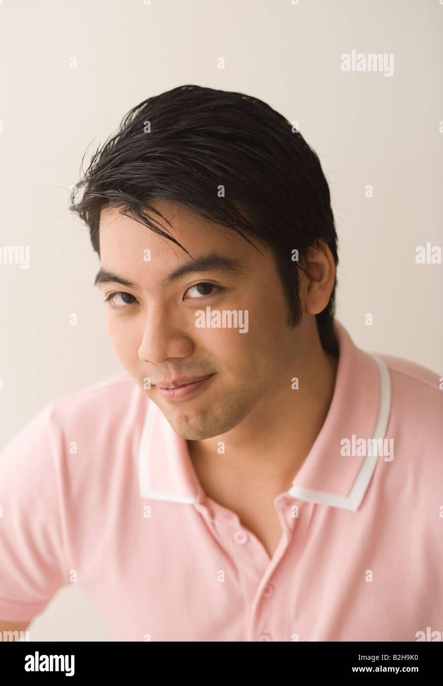 Portrait of a young man grinning Stock Photo - Alamy