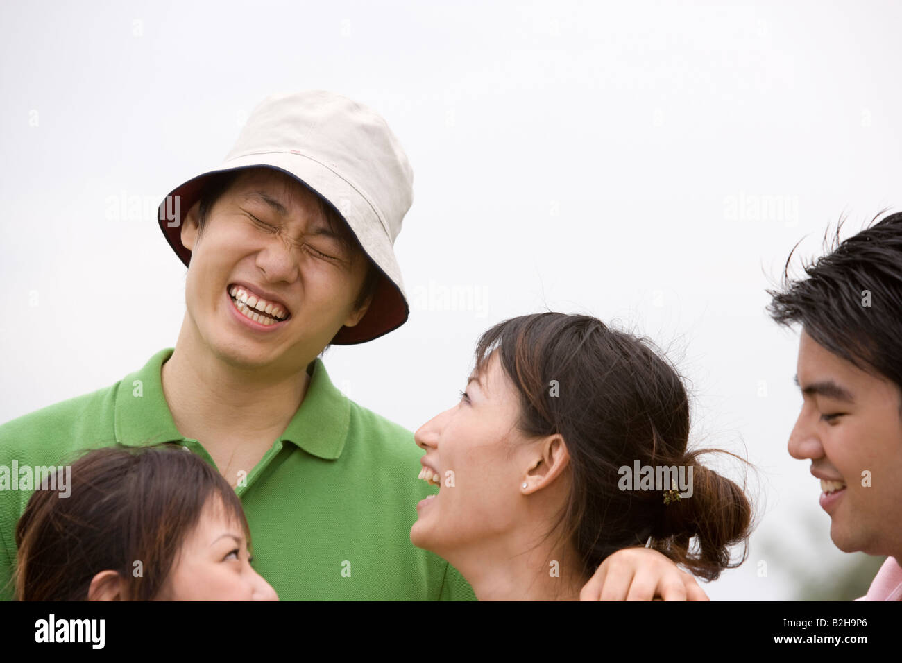 Two couples laughing together Stock Photo - Alamy