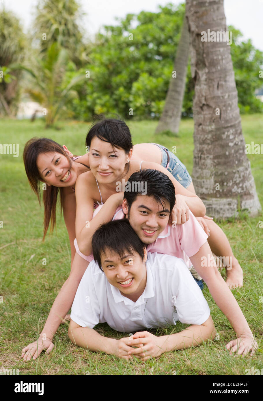 Portrait of two young couples stacking on each other Stock Photo - Alamy