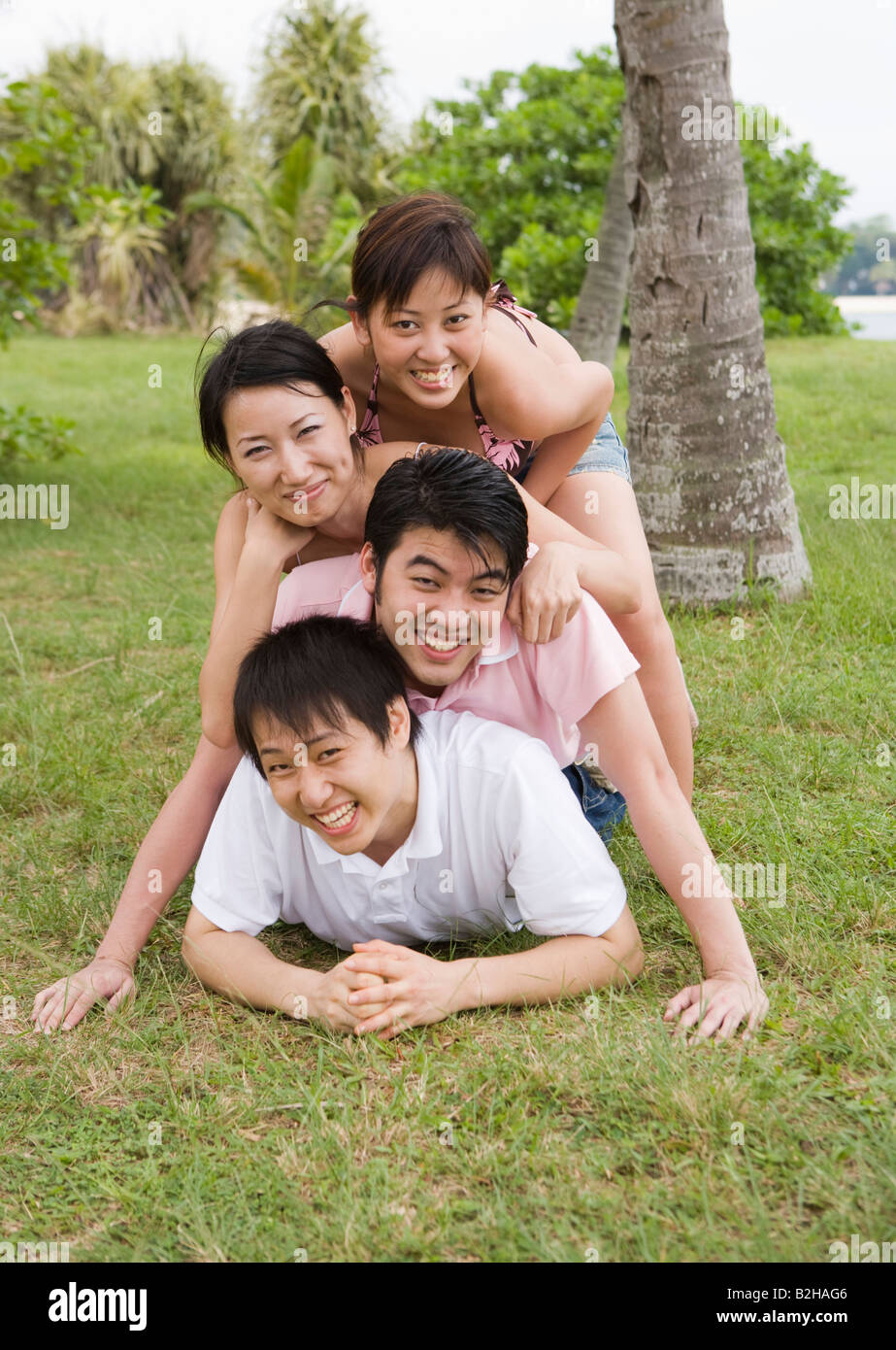 Portrait of two young couples stacking on each other Stock Photo - Alamy