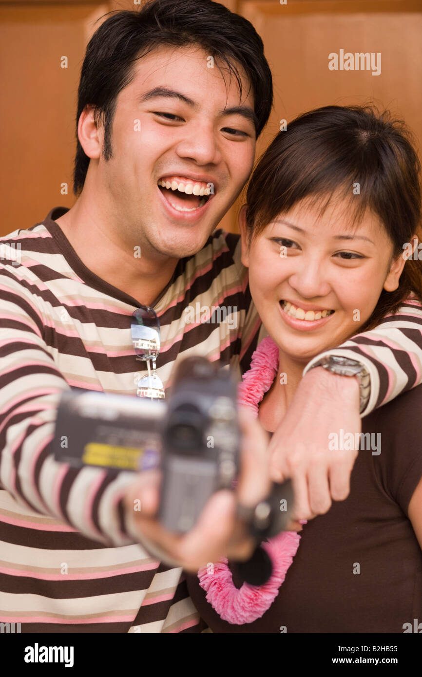 Young couple filming themselves Stock Photo - Alamy