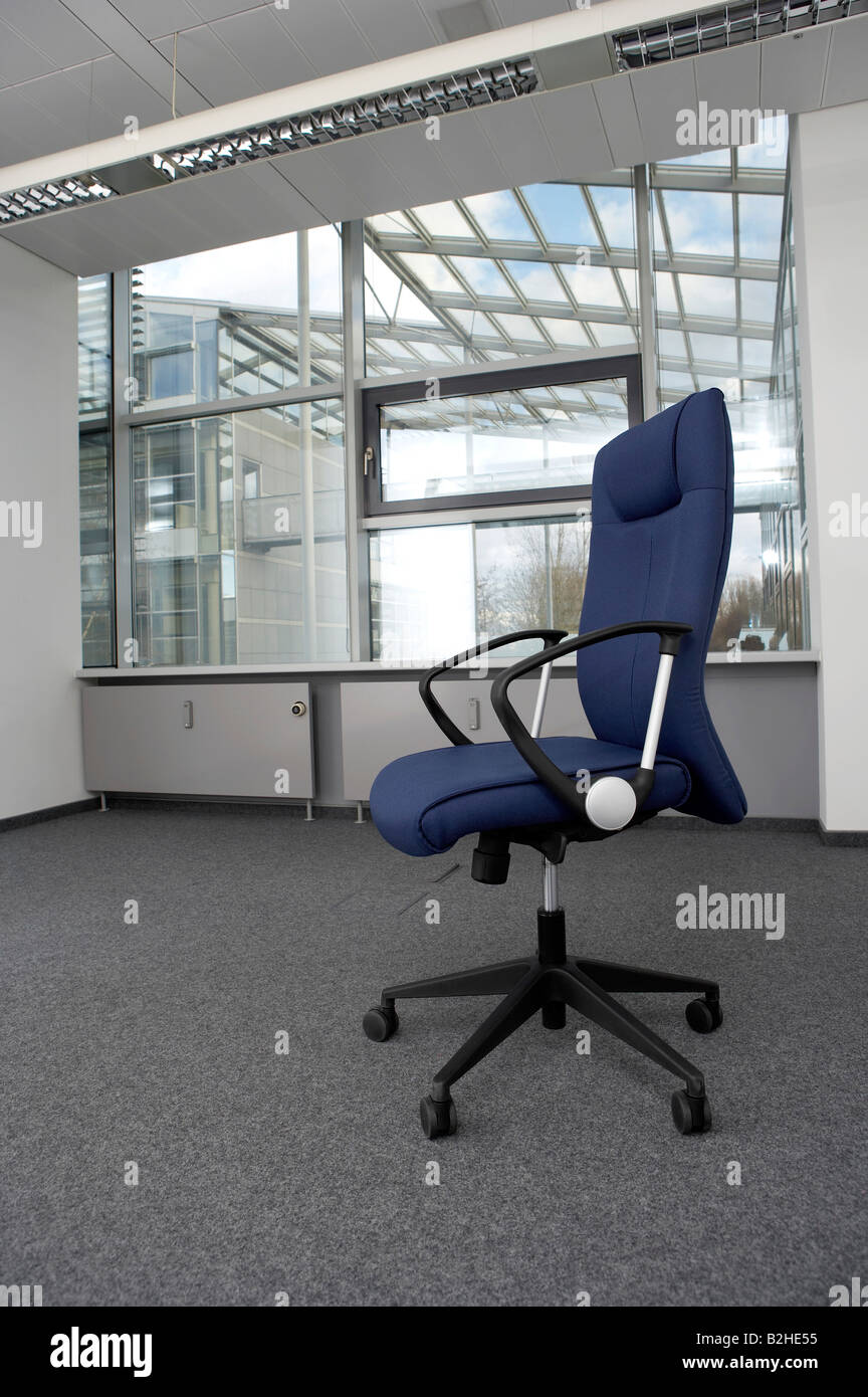 still life of chair in empty office space Stock Photo - Alamy