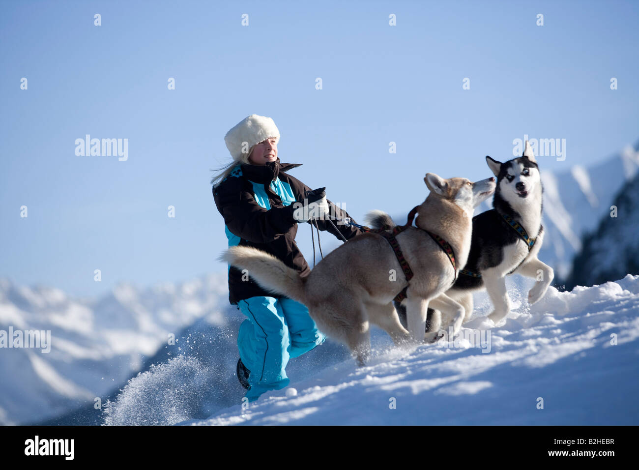 girl walking with her two huskies in the mountains Stock Photo - Alamy