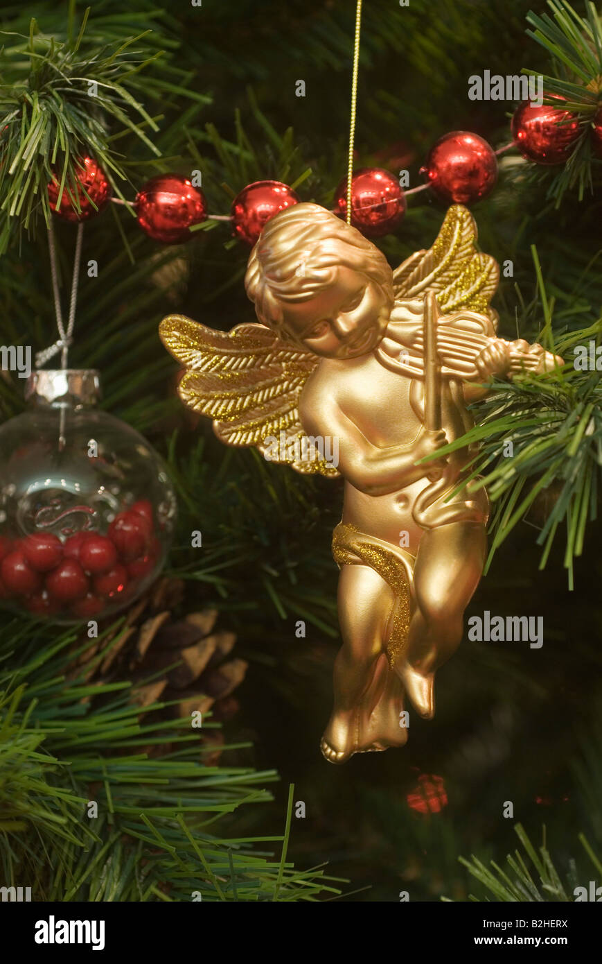 still life of golden angel hanging on christmas tree Stock Photo - Alamy